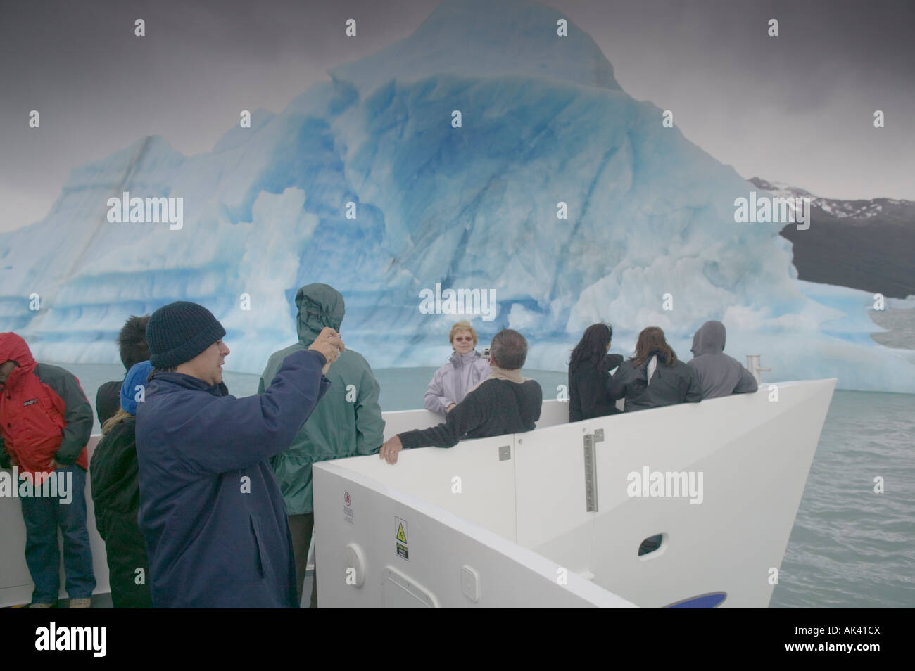 Passengers on a ferry looking at an iceberg Lake Argentino Los ...