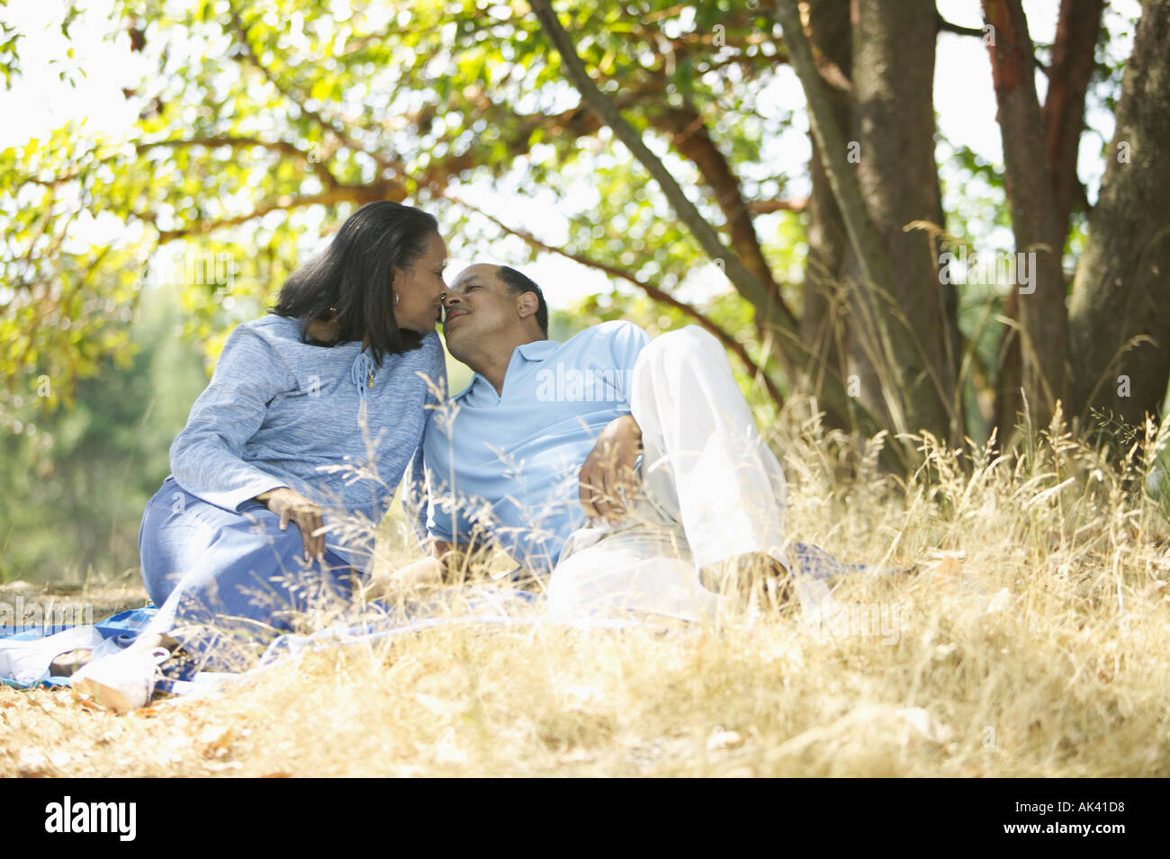 Mature couple cuddling kissing hi-res stock photography and images - Alamy