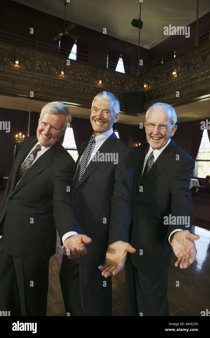 Three senior men holding out their hands on the dance floor Stock Photo ...