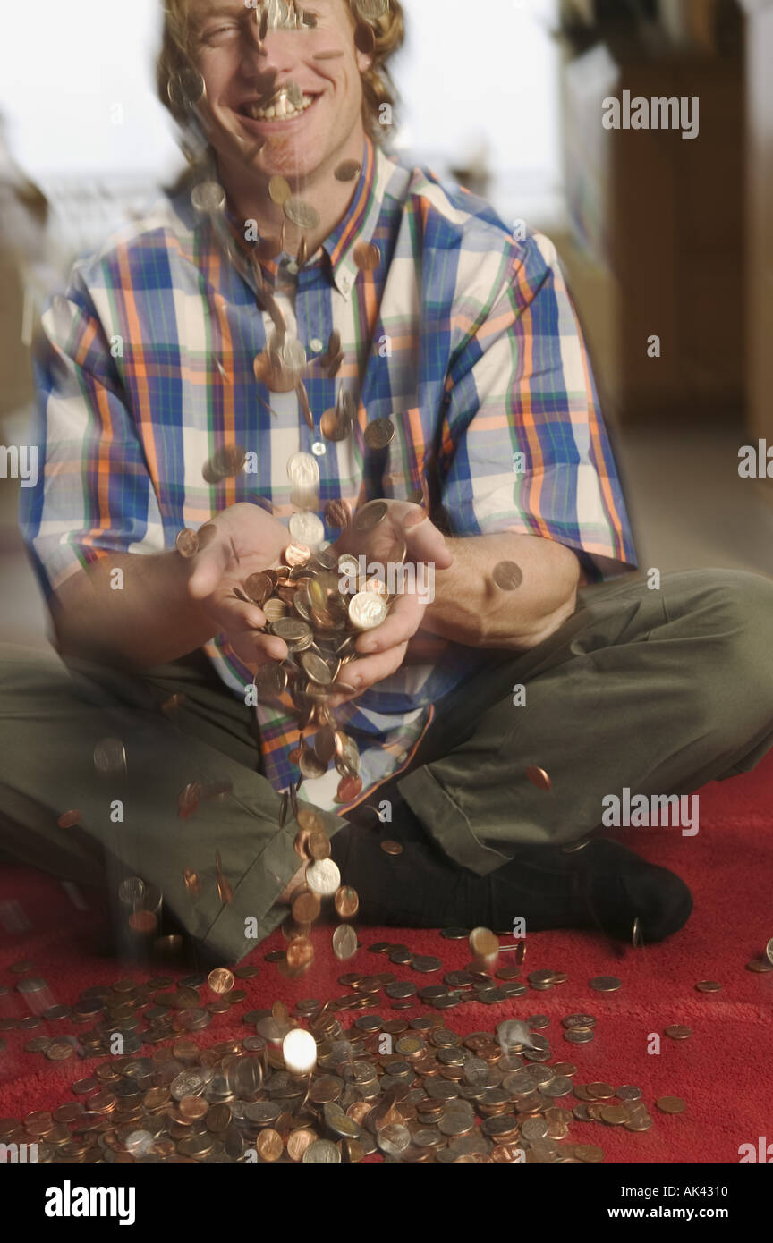 Man catching falling coins Stock Photo - Alamy