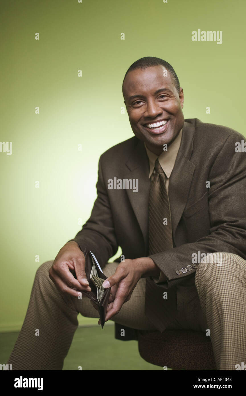 Man holding his wallet open Stock Photo - Alamy
