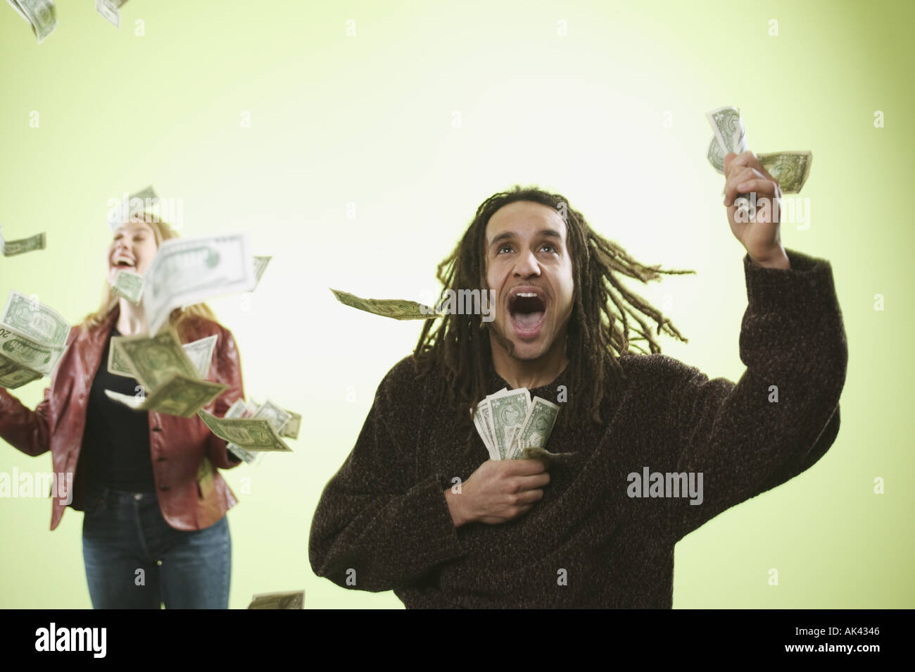Man and woman catching falling money Stock Photo - Alamy