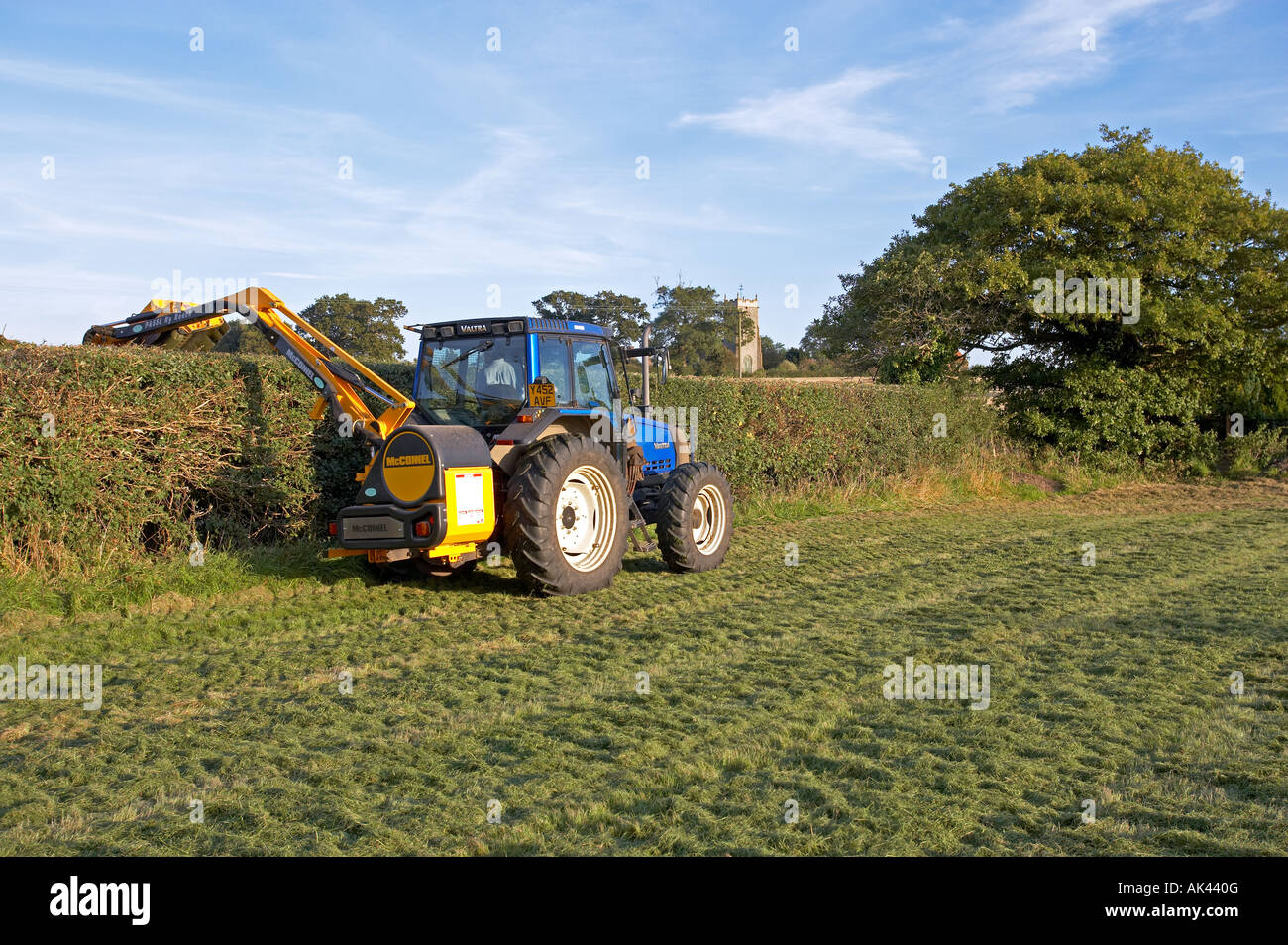 A Farmer trimming his hedges at harvest time in Norfolk, UK Stock Photo ...