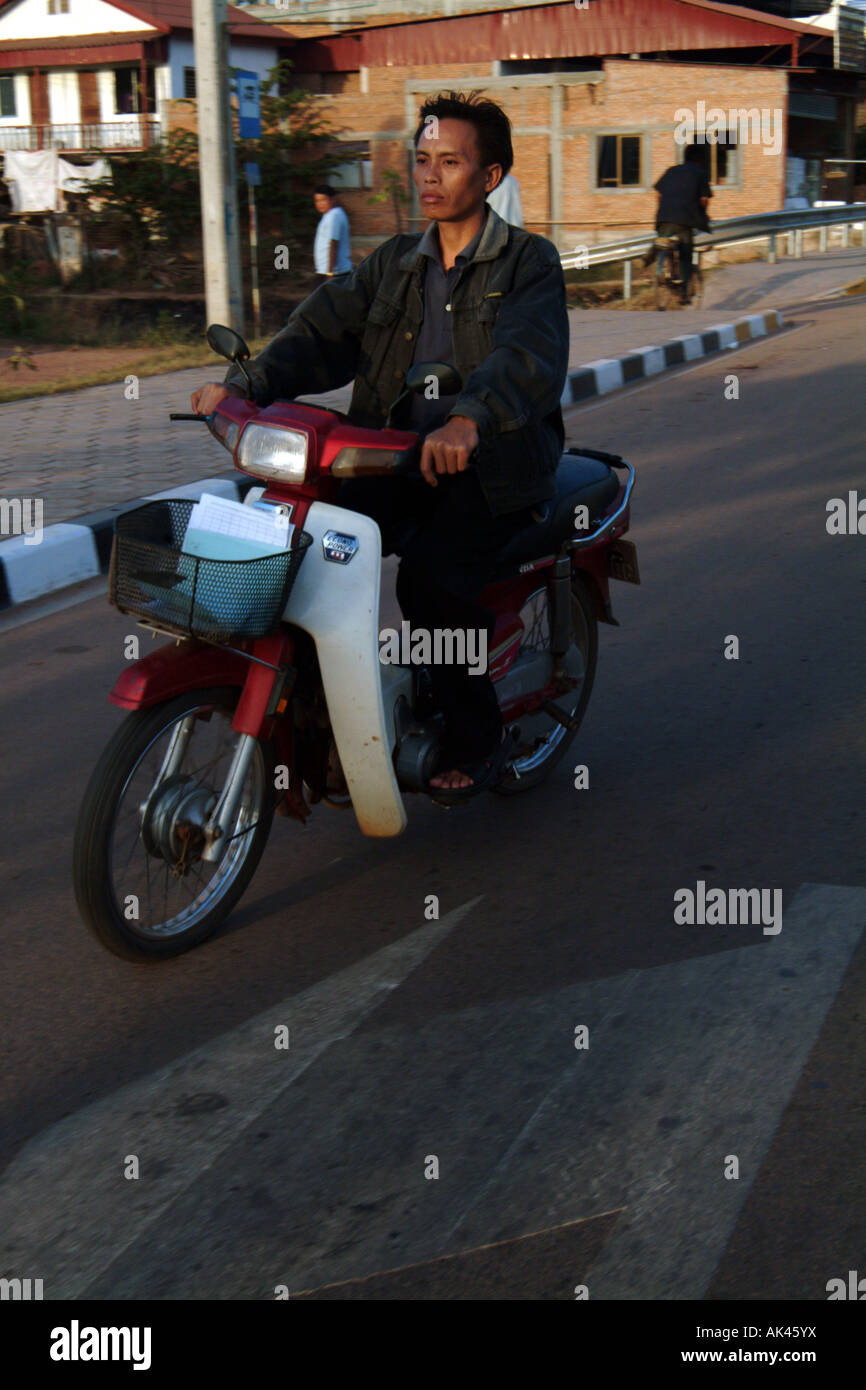 A man on his motorcycle in Vientiane Laos Stock Photo - Alamy
