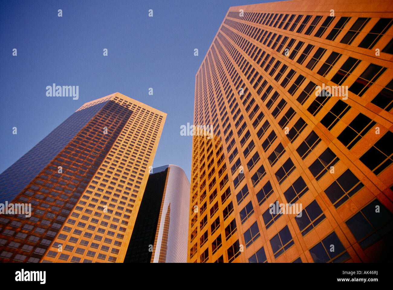 Upward view of office buildings at sunset in Central Business District ...