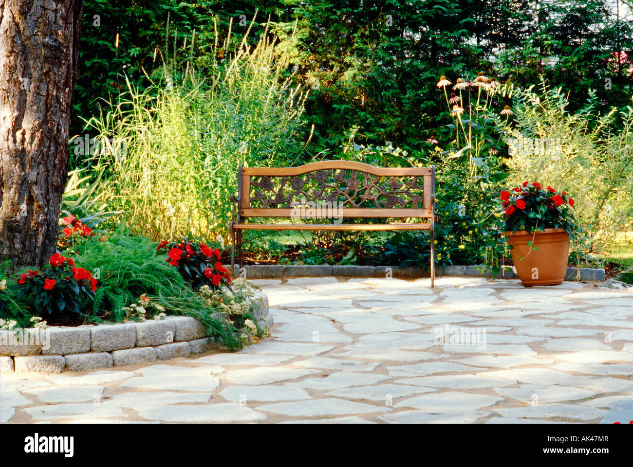 Bench in a garden setting Stock Photo - Alamy