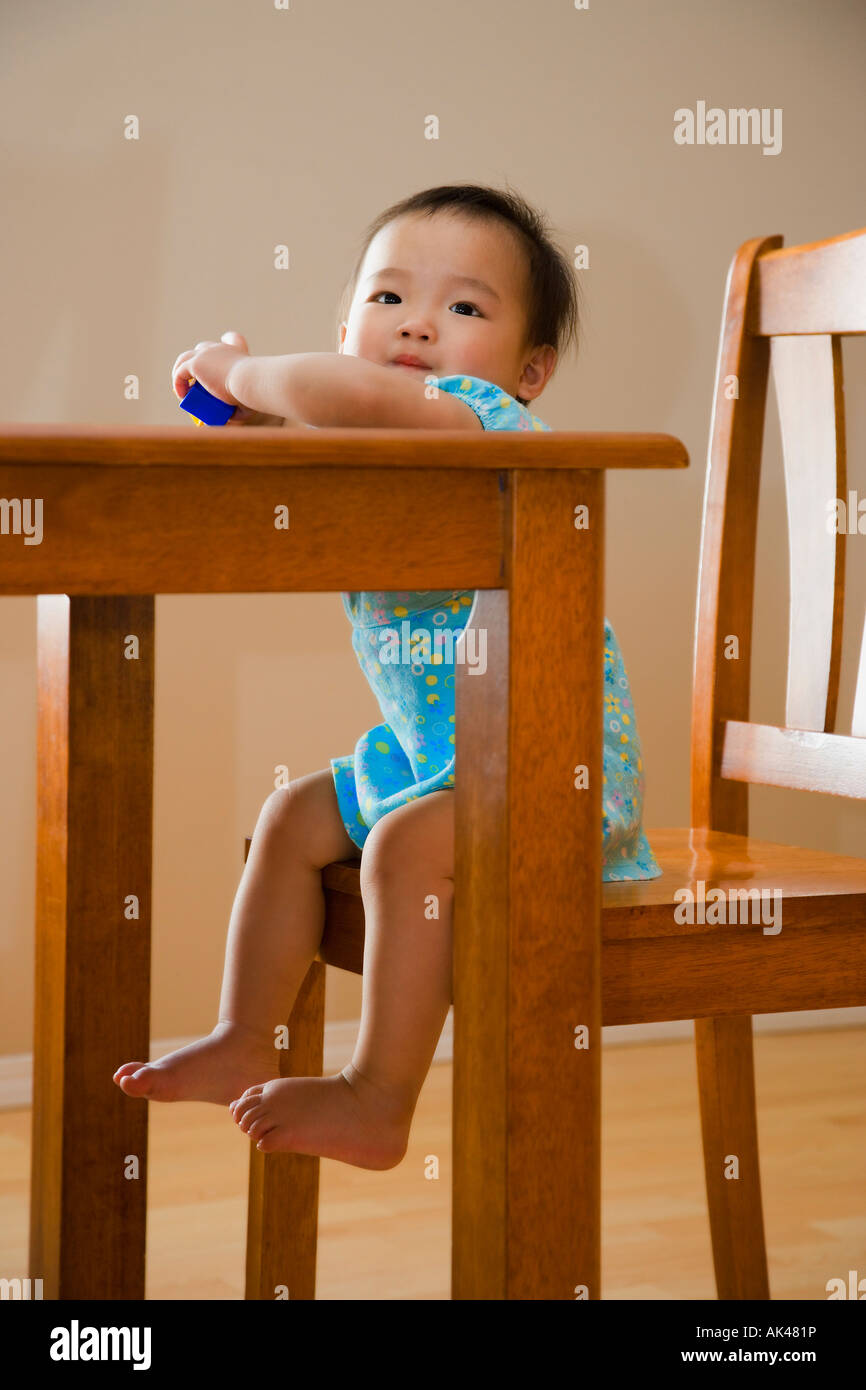 Toddler sitting at table Stock Photo - Alamy