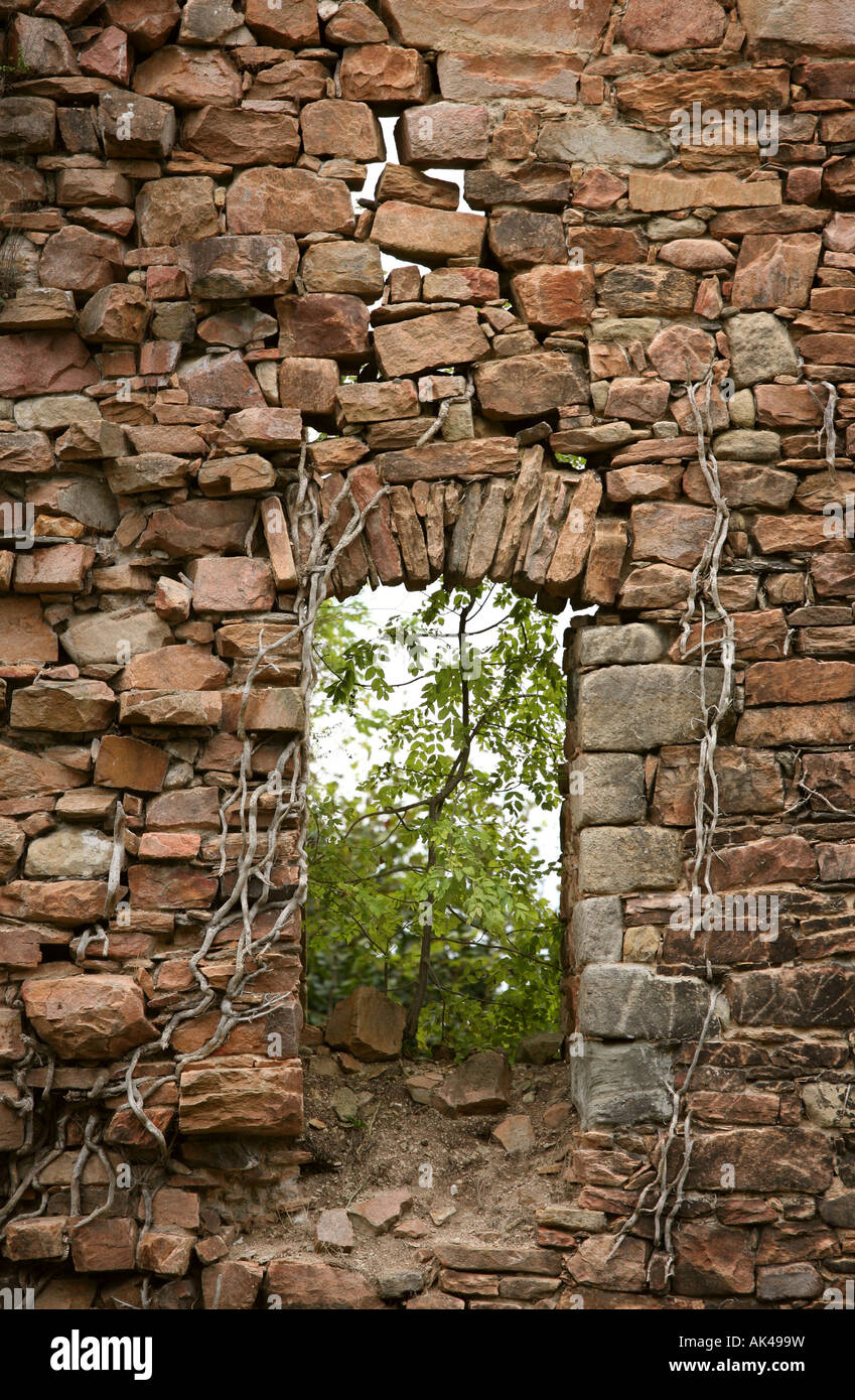 Crumbling stone wall with arched window Stock Photo - Alamy