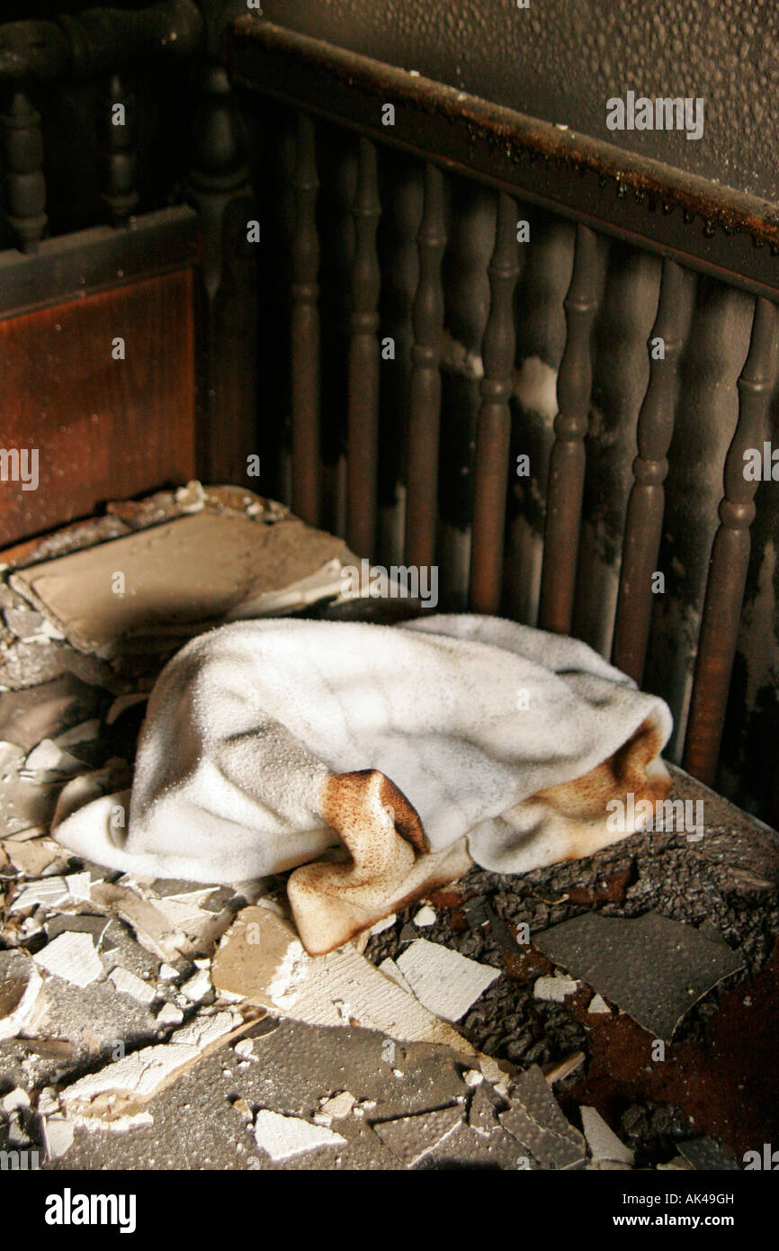 Burned craddle in a bedroom after a house fire Debris of drywall and ...
