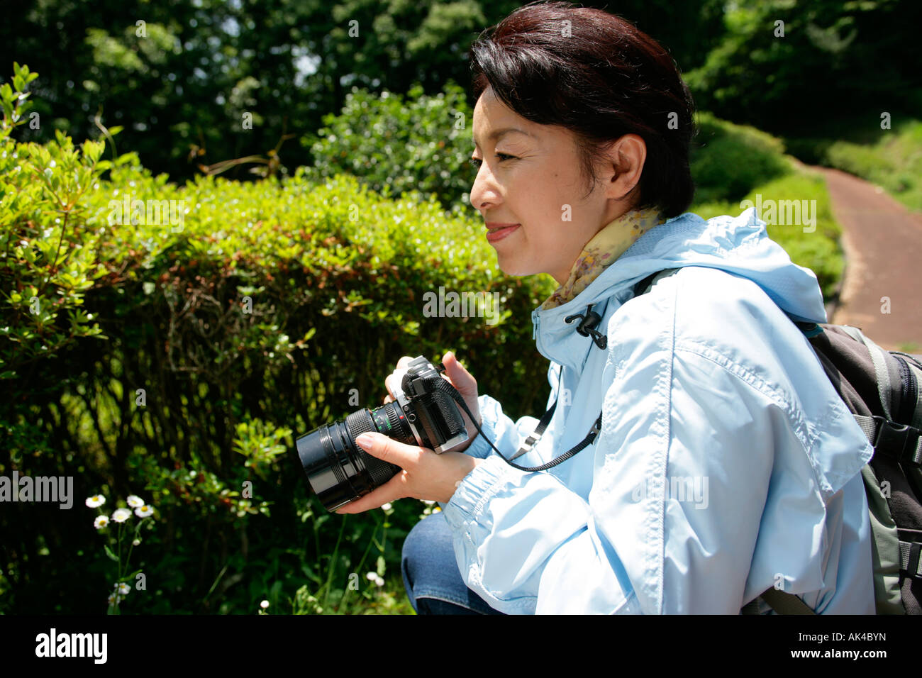 Mature woman holding camera Stock Photo - Alamy