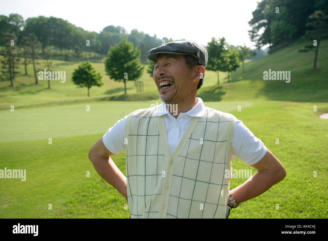 Man standing on golf course, laughing Stock Photo - Alamy