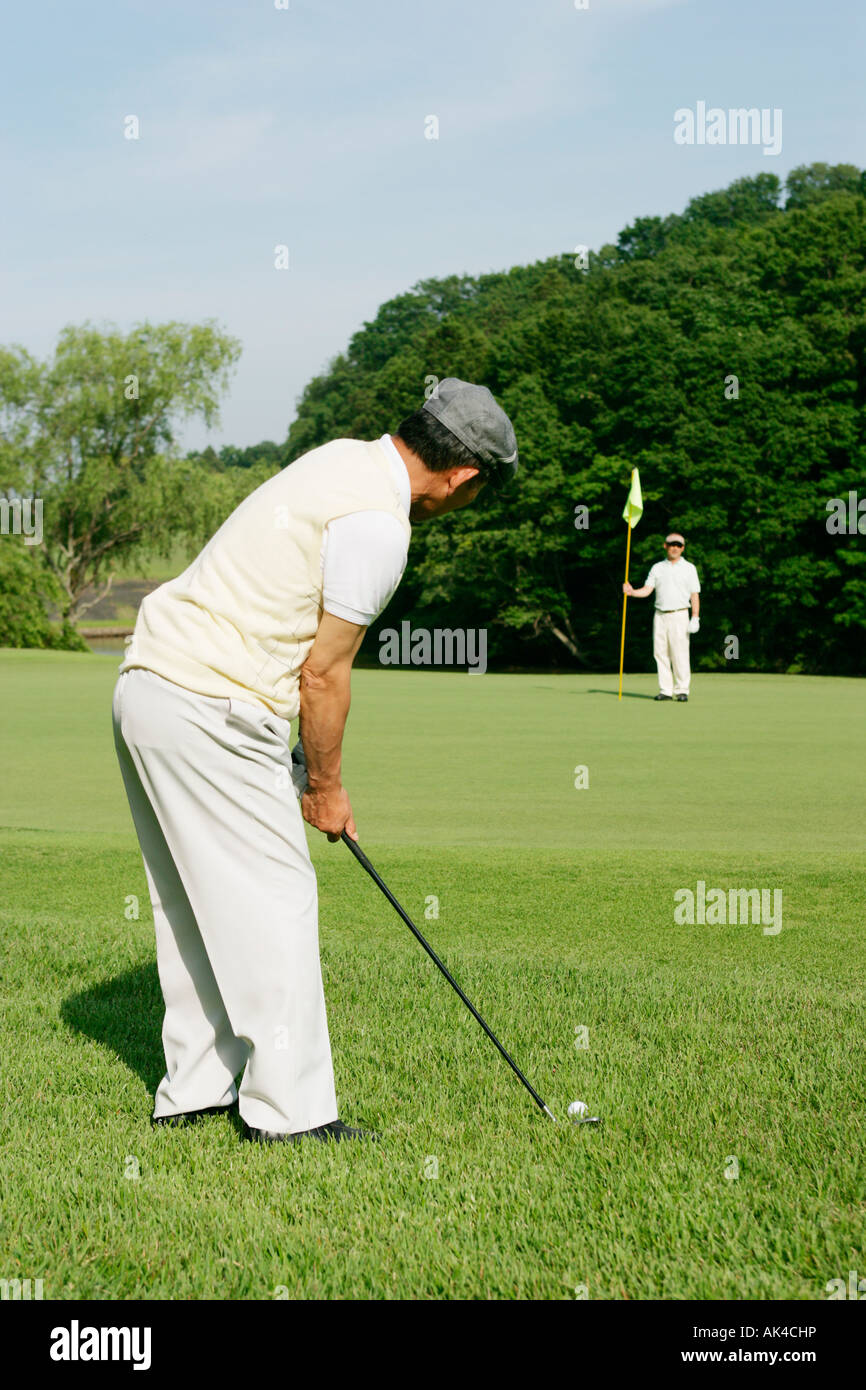 Two men playing golf Stock Photo - Alamy