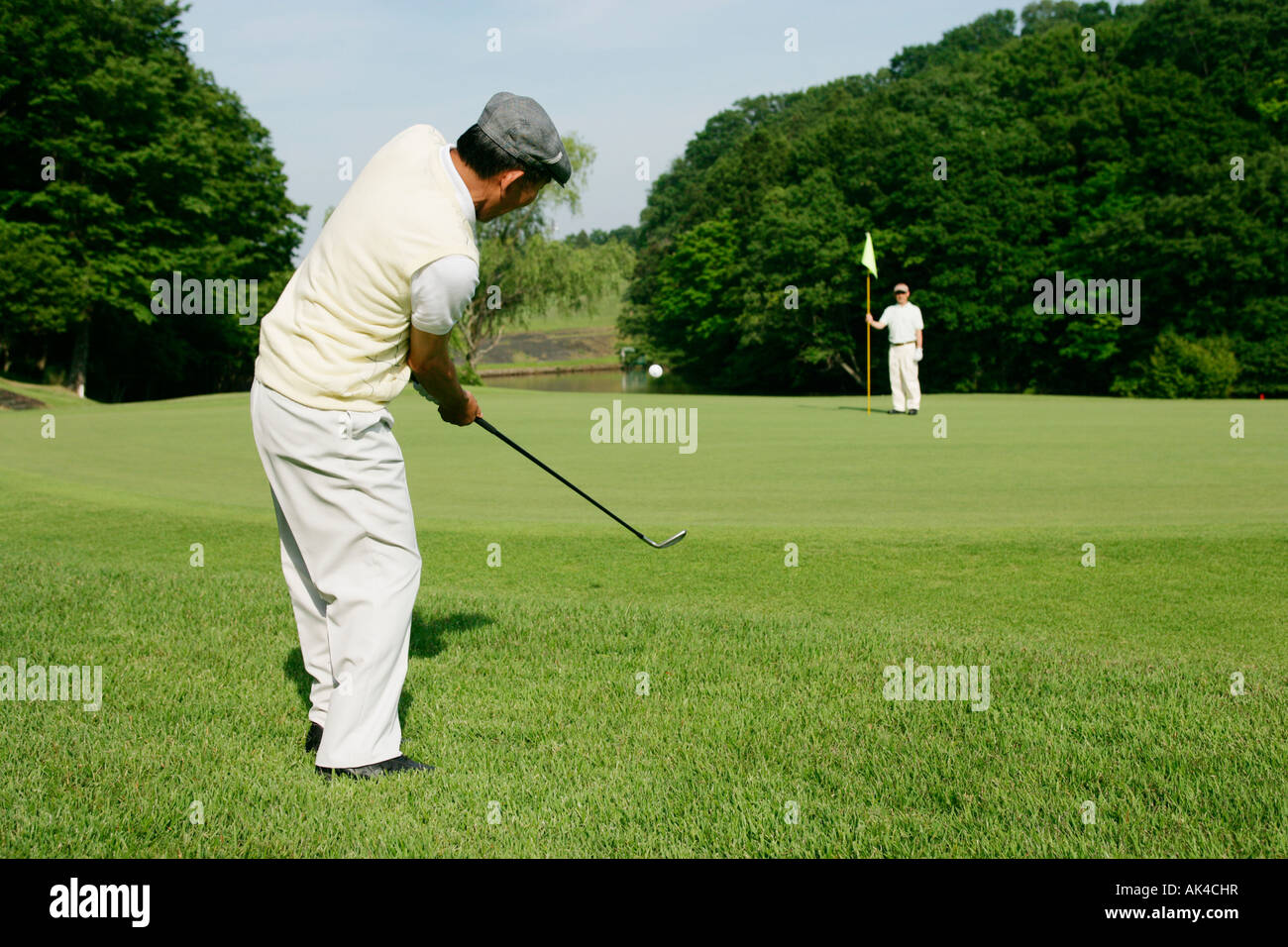 Two men playing golf Stock Photo - Alamy