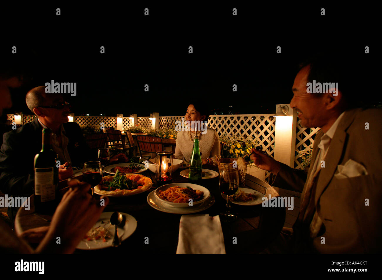 Four adults having dinner Stock Photo - Alamy
