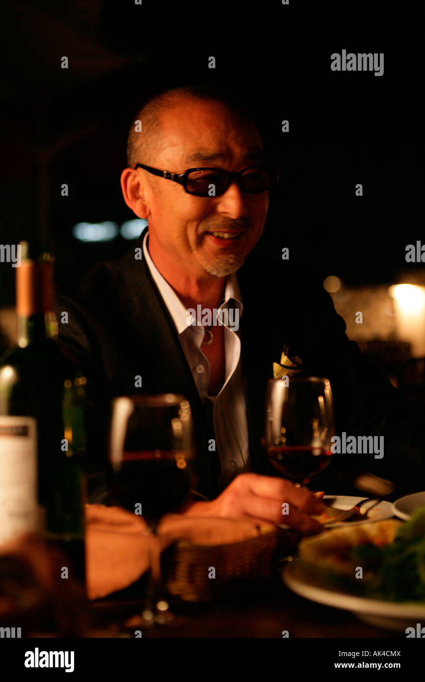Man sitting at dinner table, smiling Stock Photo - Alamy
