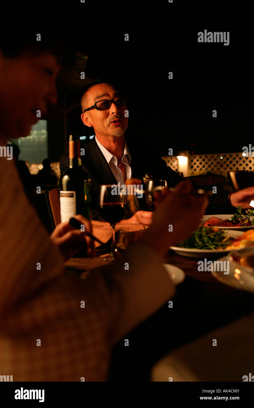 Man relaxing with friends over dinner Stock Photo - Alamy