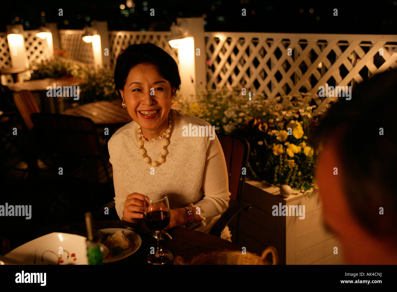Woman relaxing with friends over dinner Stock Photo - Alamy