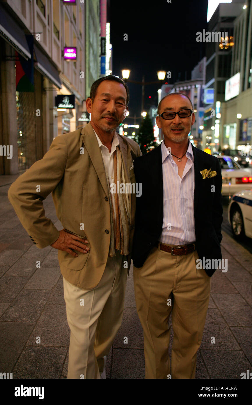Two men standing on the street at night, smiling Stock Photo - Alamy