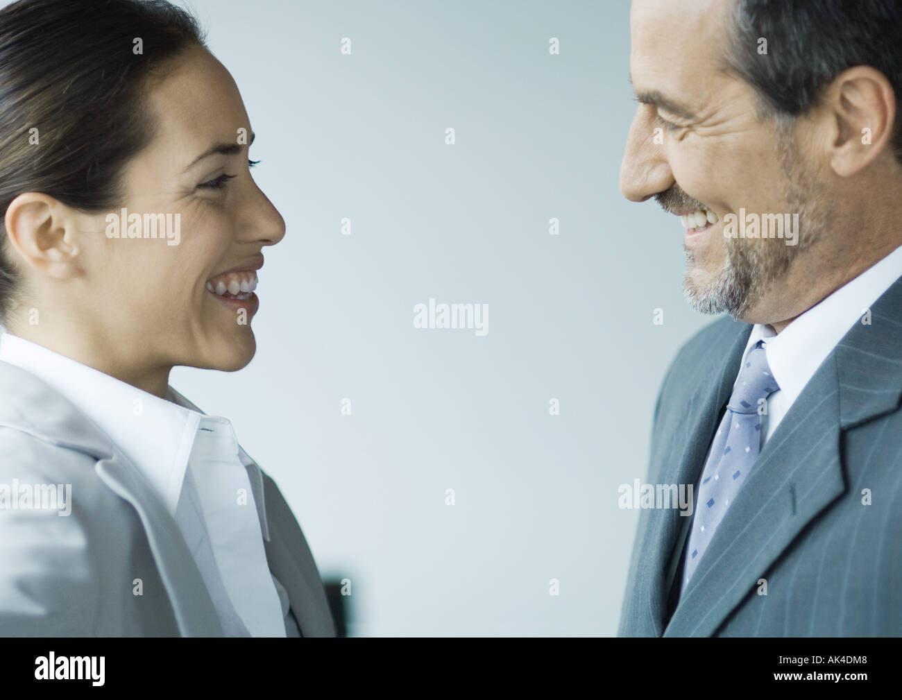 Business colleagues smiling at each other Stock Photo - Alamy