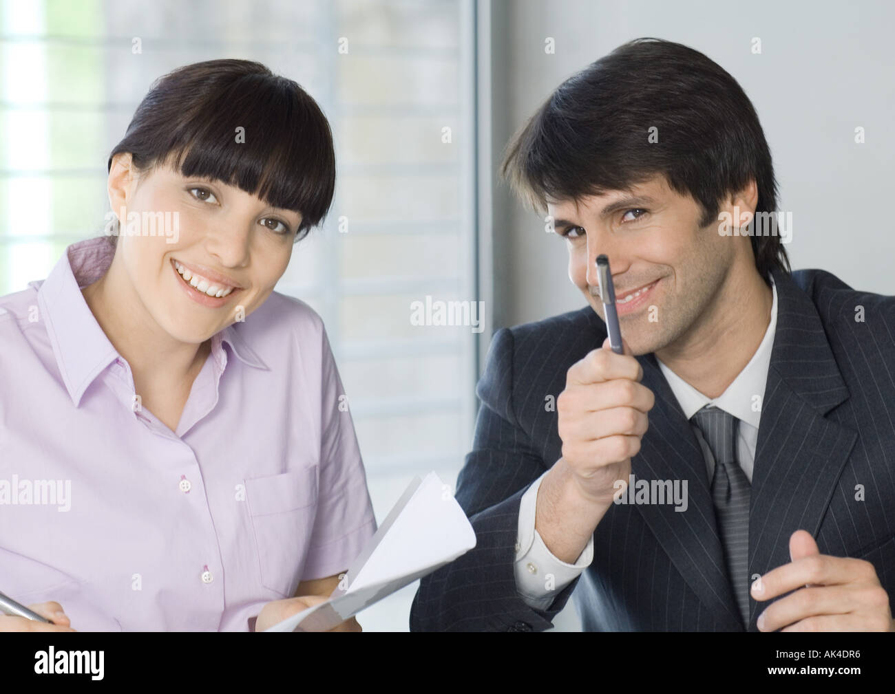 Two business colleagues smiling at camera Stock Photo - Alamy