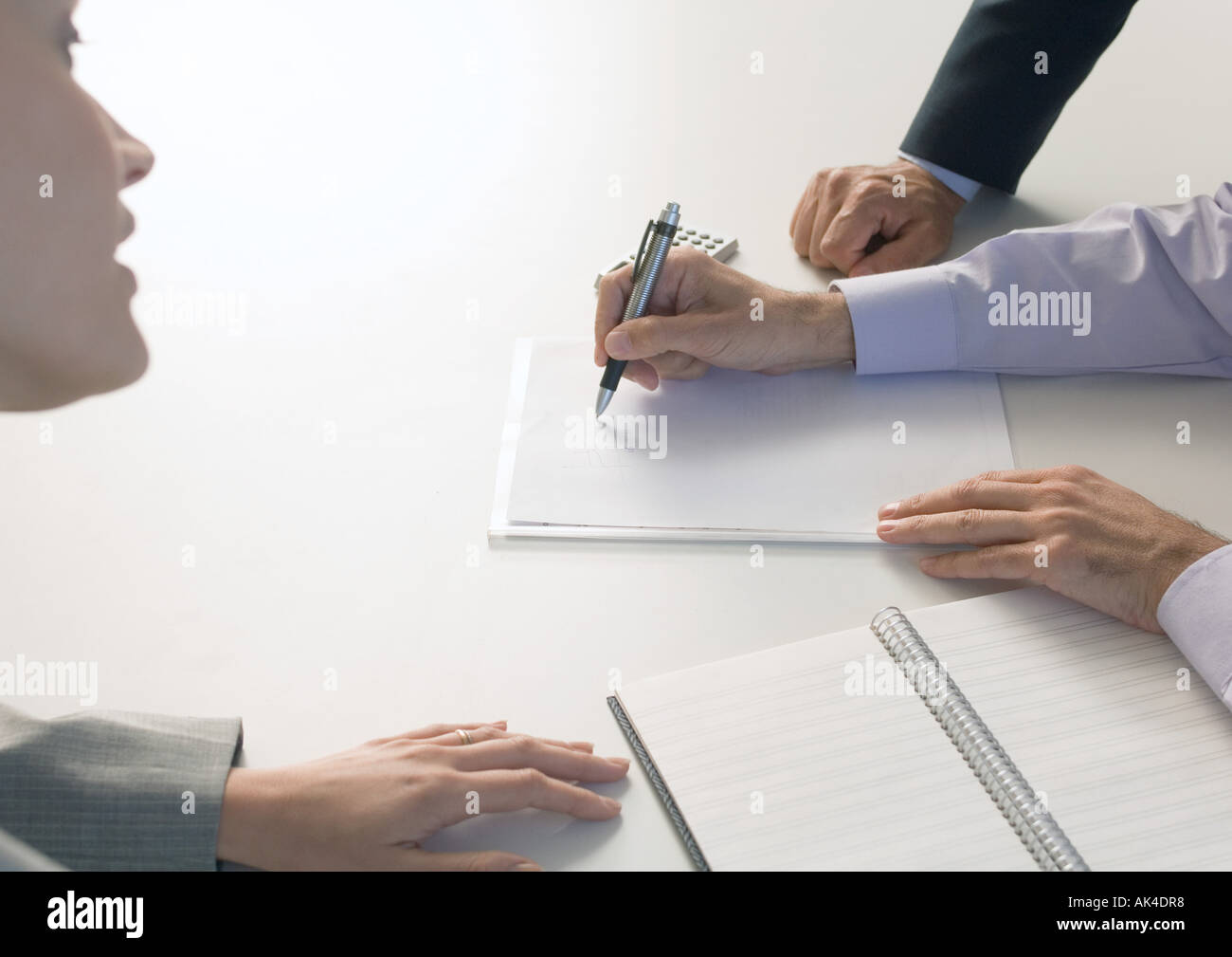 Businesspeople signing document Stock Photo - Alamy