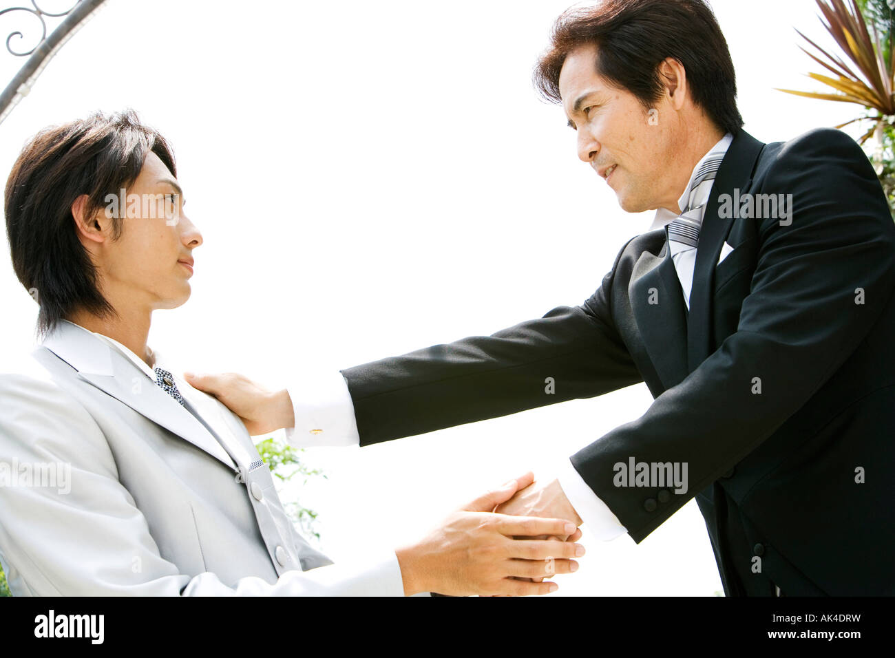 Two men shaking hands Stock Photo - Alamy