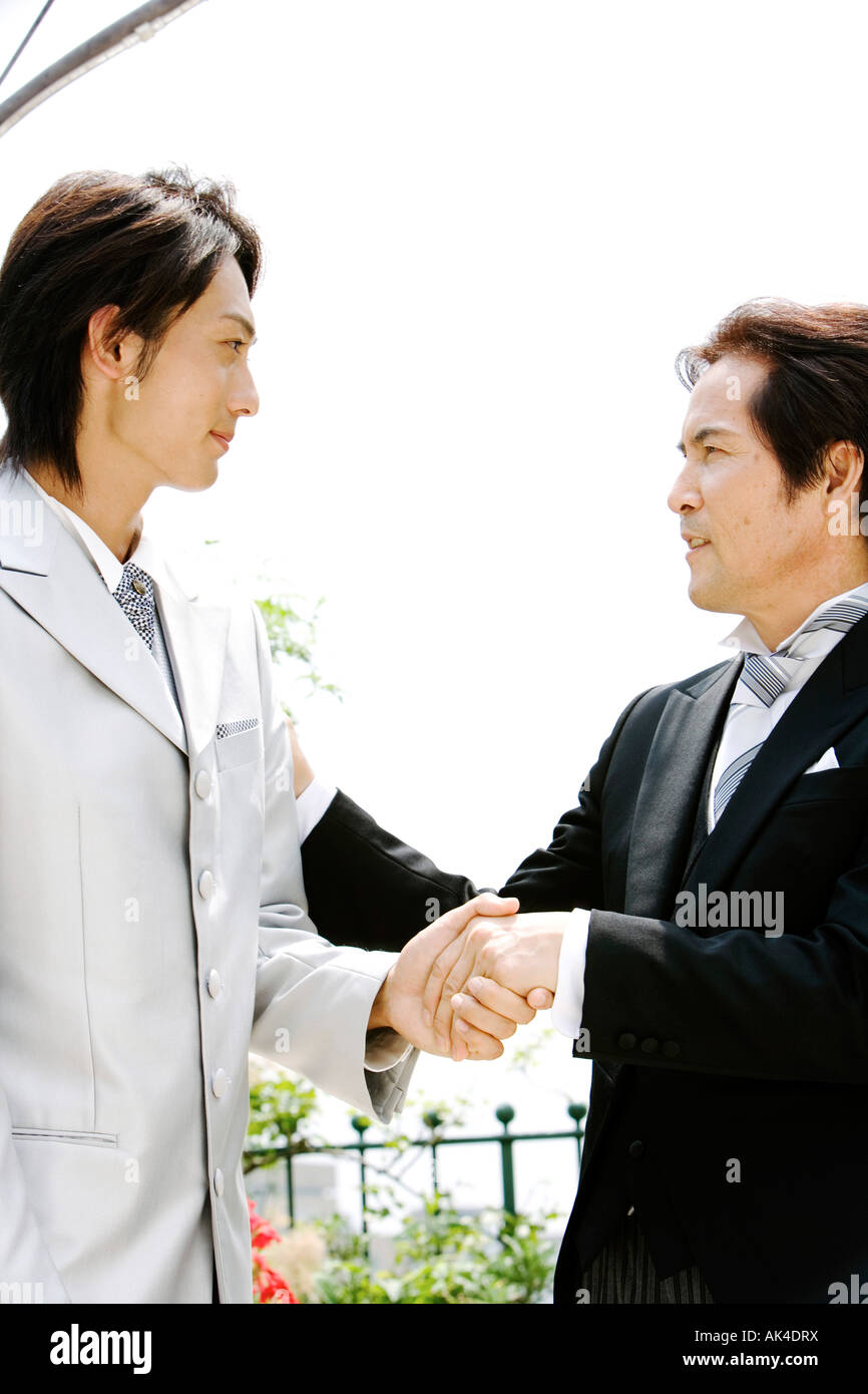 Two men shaking hands Stock Photo - Alamy