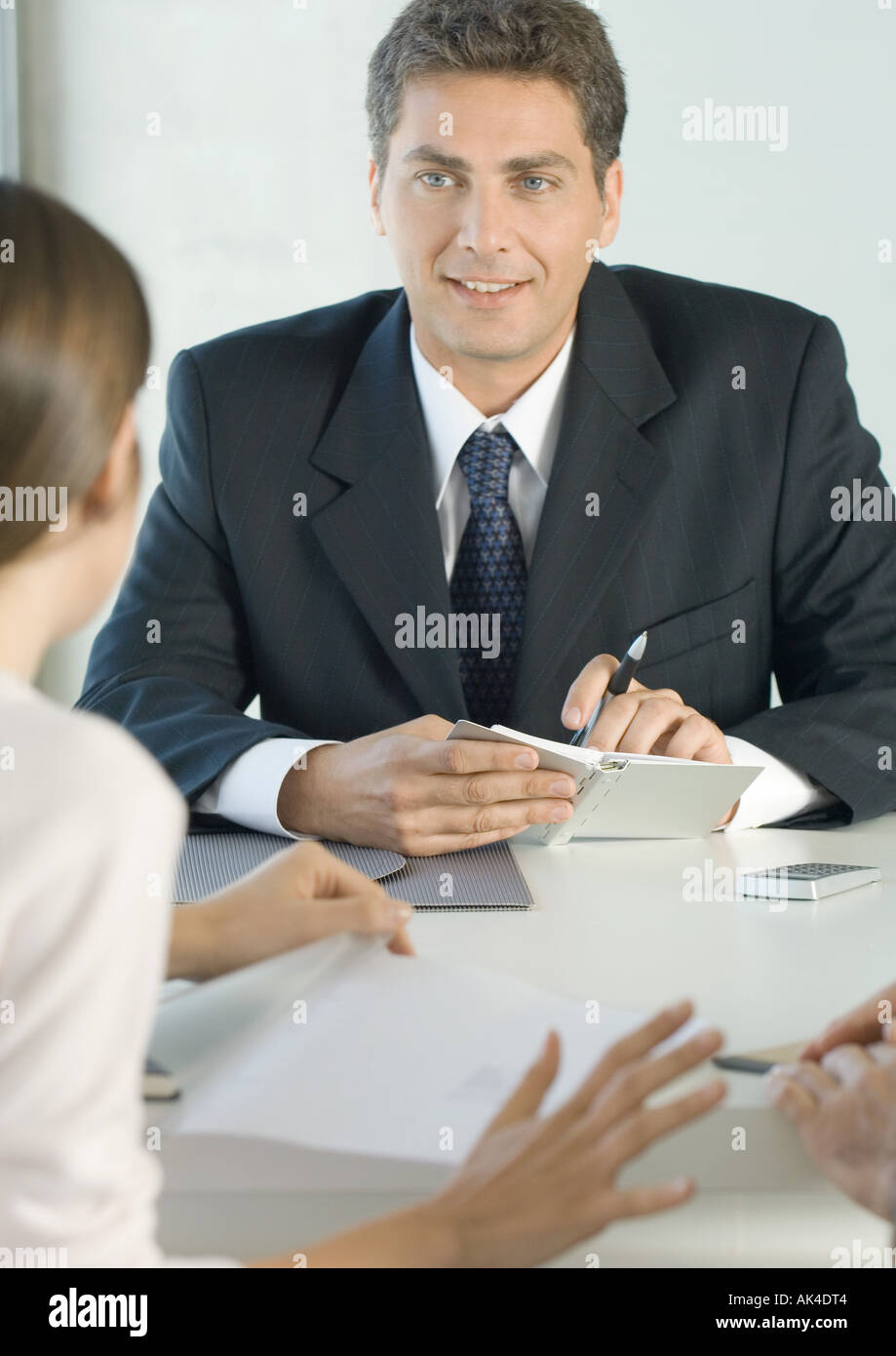 Woman sitting table listening hi-res stock photography and images - Alamy