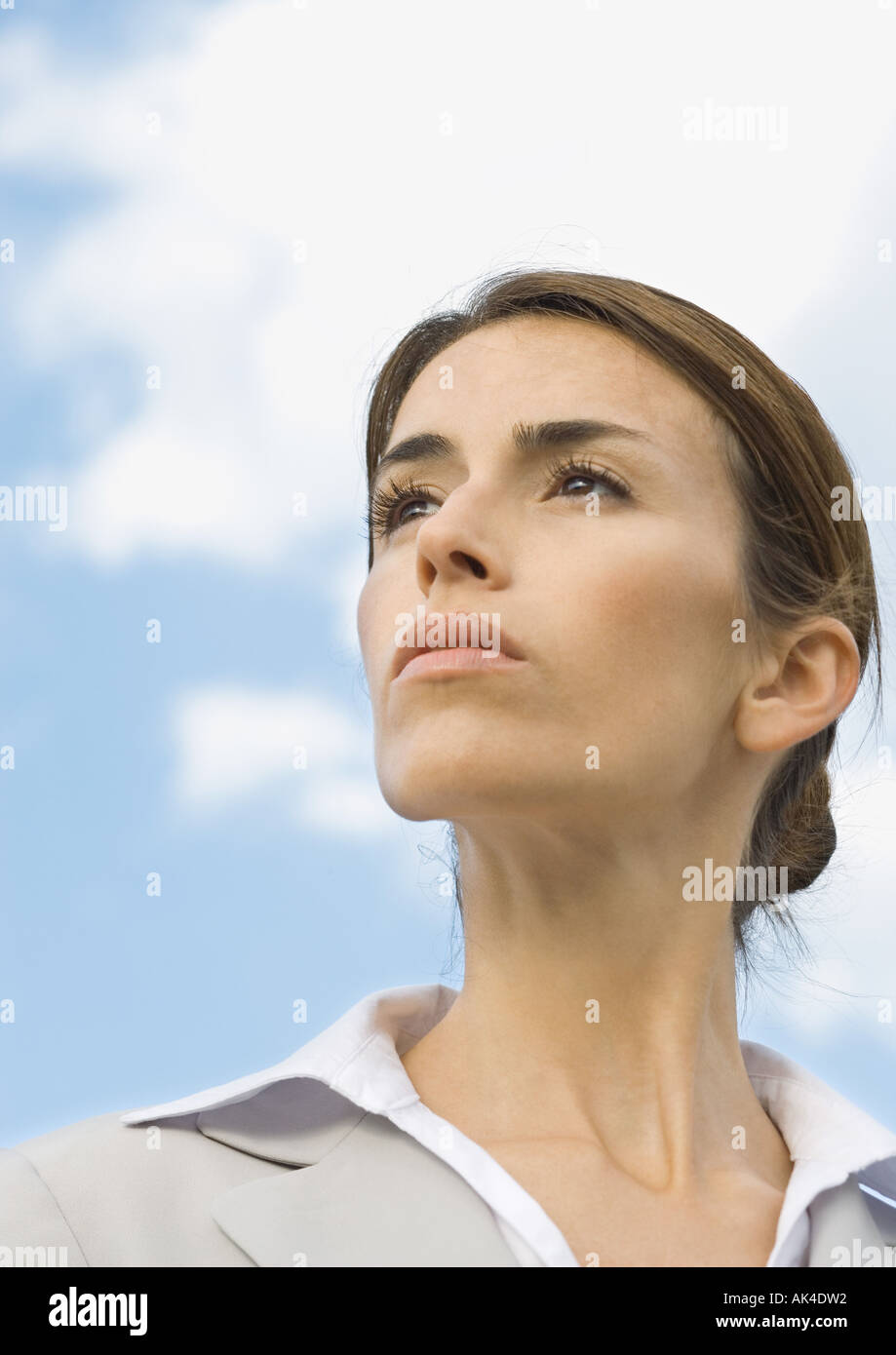 Woman looking into distance, portrait, low angle view Stock Photo - Alamy