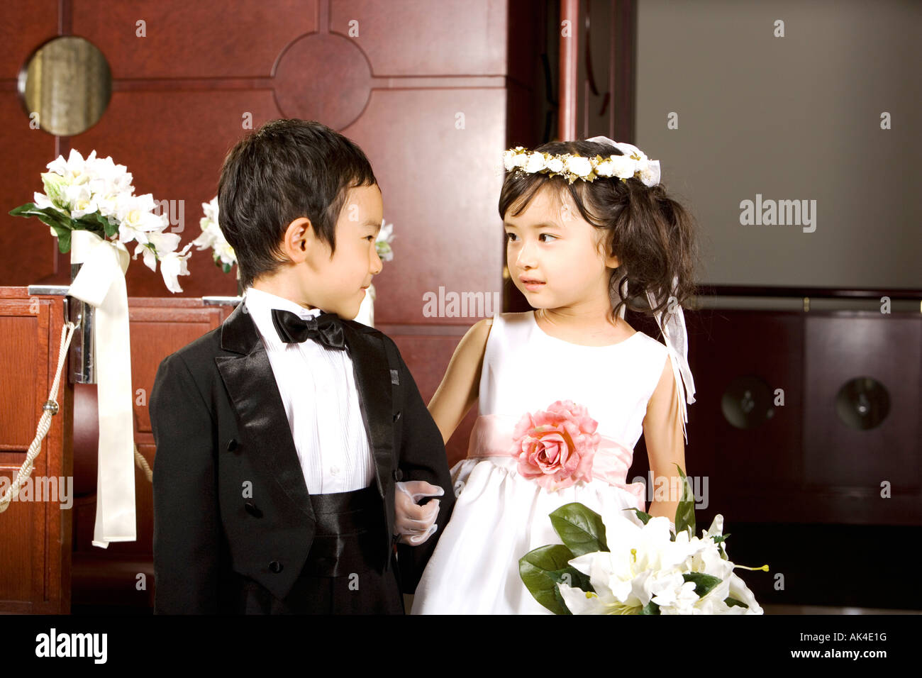 Pageboy and flower girl standing in church Stock Photo - Alamy