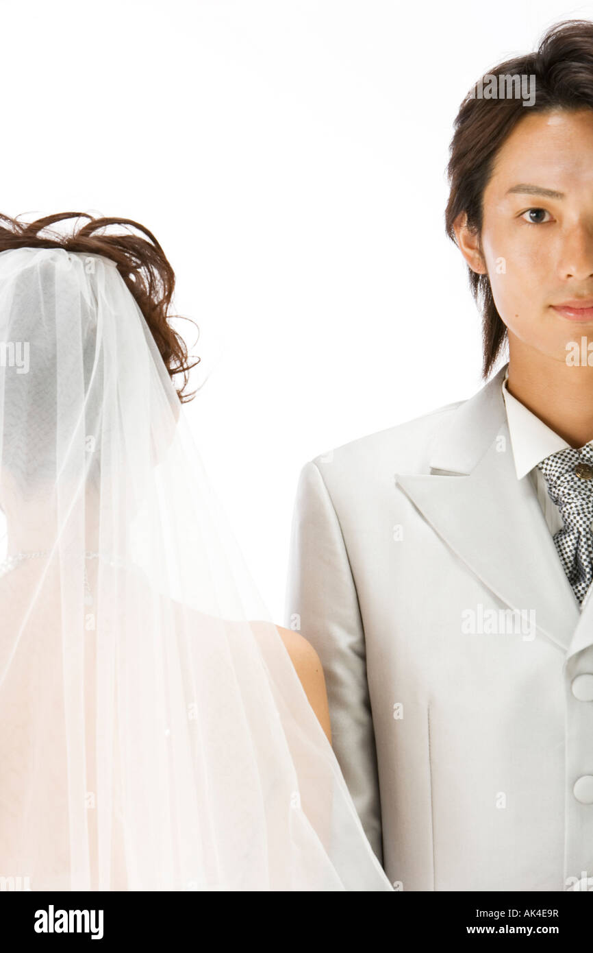 Front view of bridegroom and rear view of bride Stock Photo - Alamy