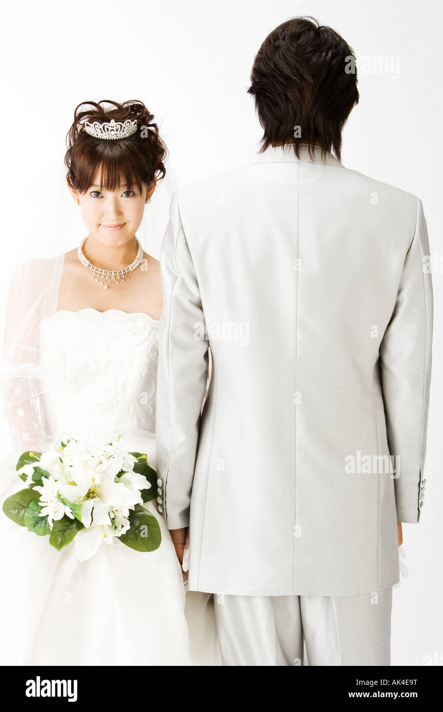 Front view of bride and rear view of bridegroom Stock Photo - Alamy