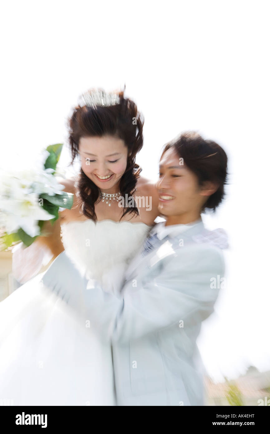 Bridegroom lifting up the bride Stock Photo - Alamy
