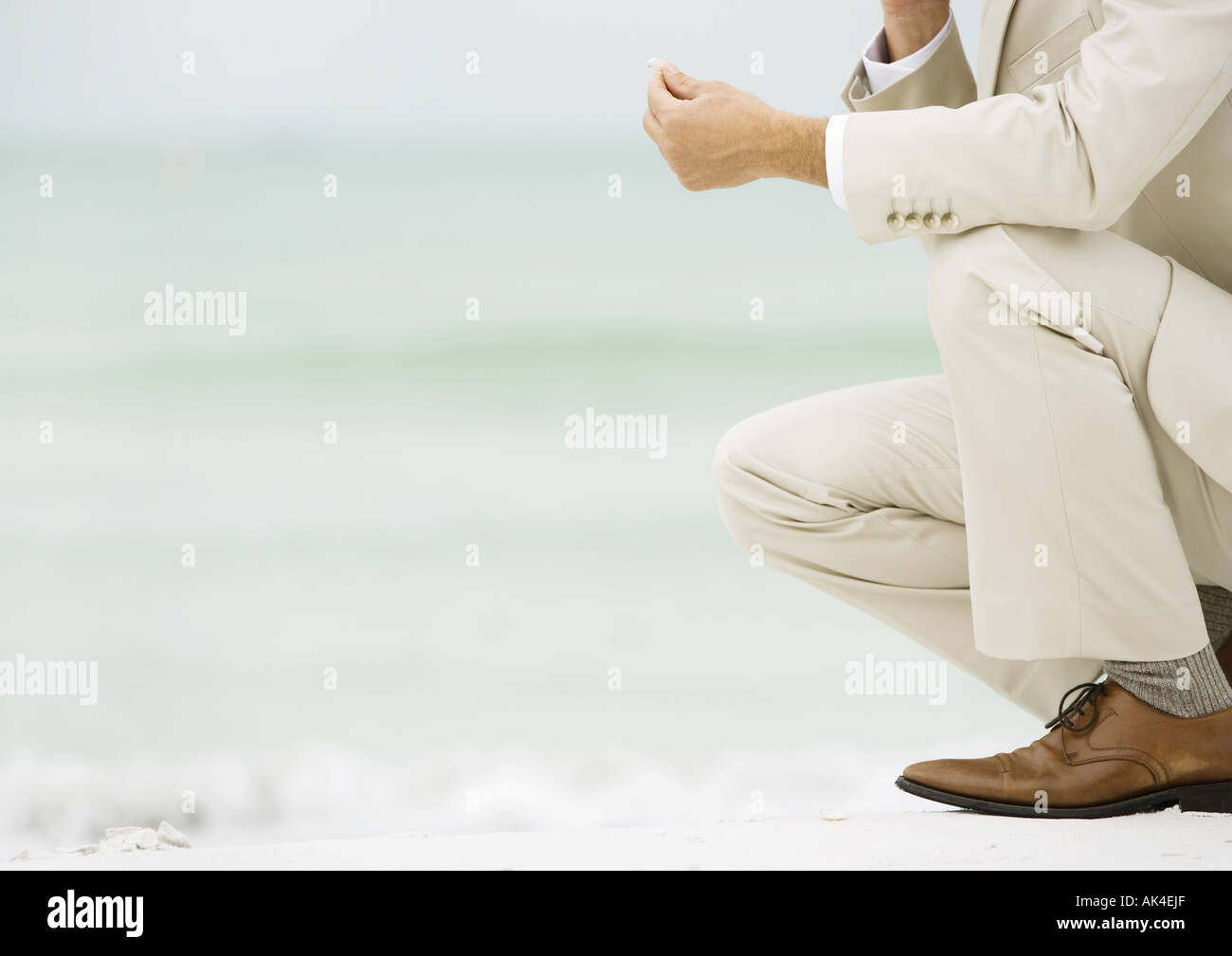 Man in suit crouching on hi-res stock photography and images - Alamy