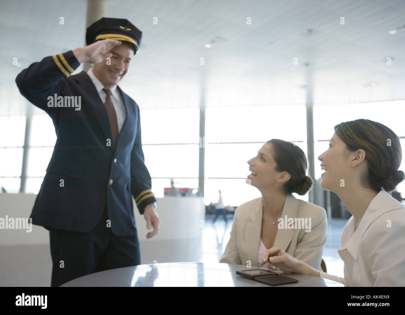 Airline pilot saluting two female hi-res stock photography and images ...