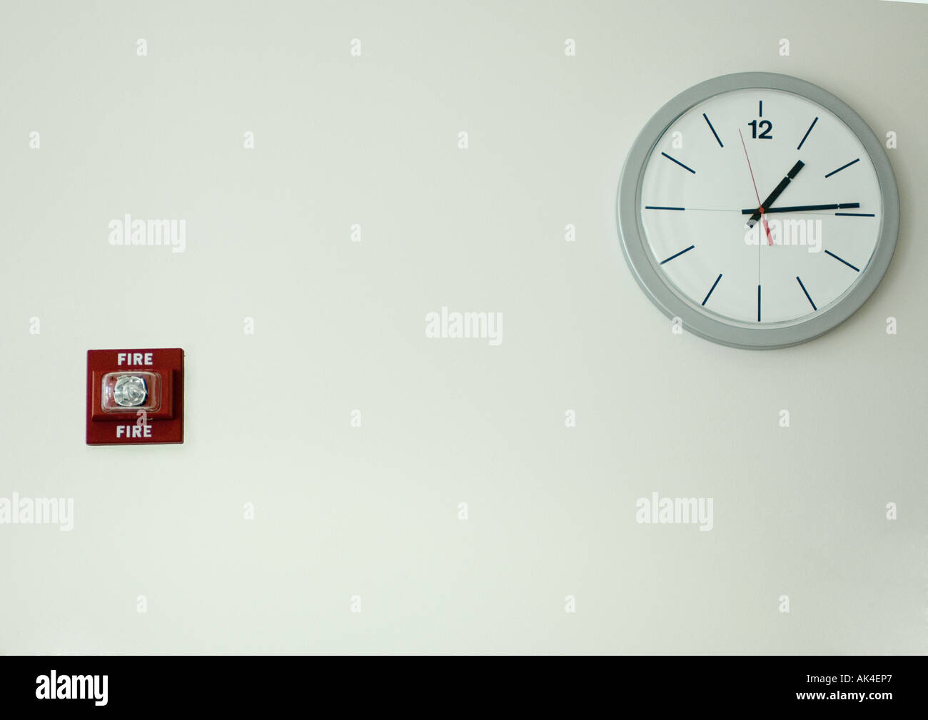Clock and fire alarm on wall Stock Photo - Alamy