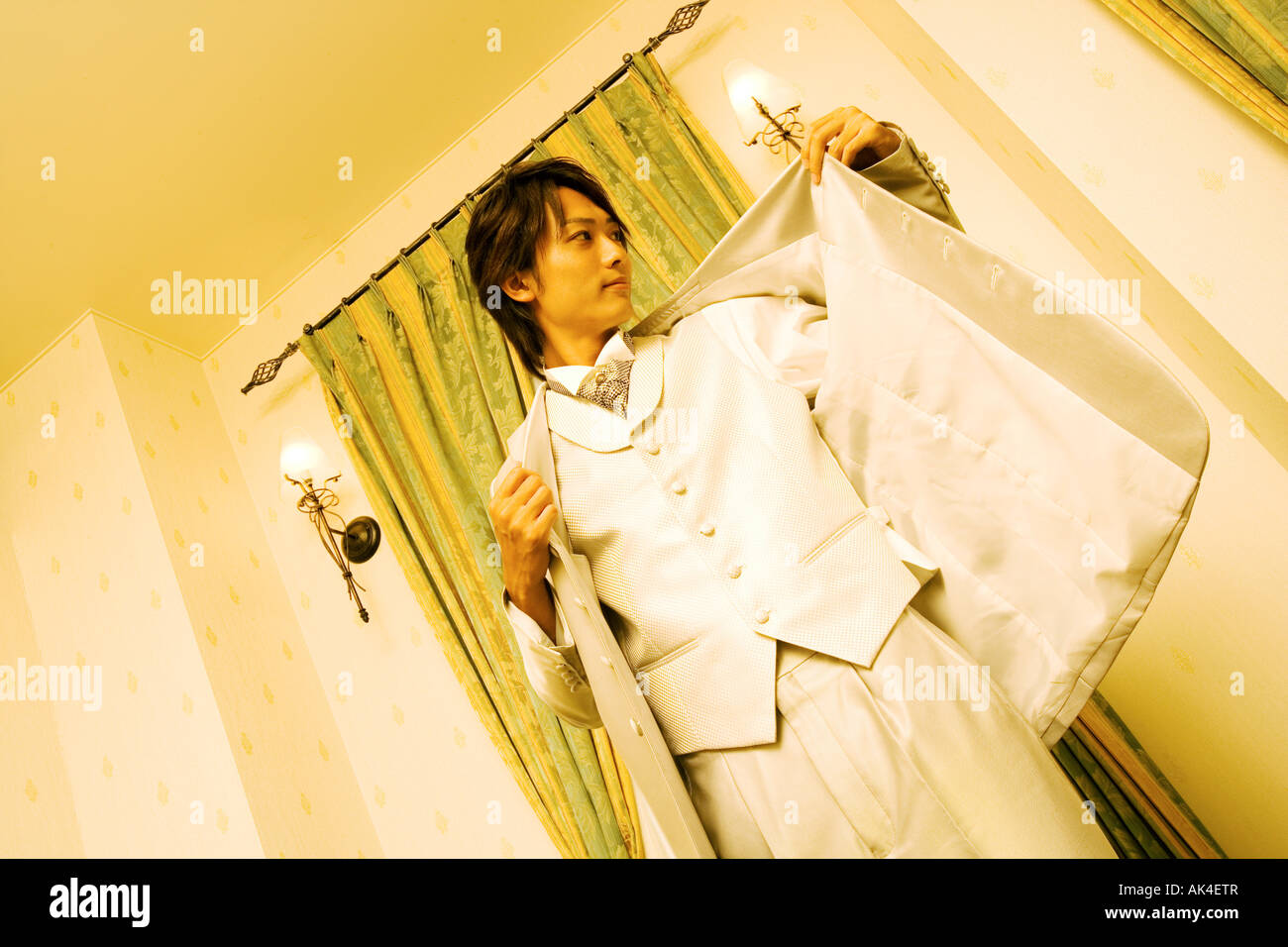 Groom putting on jacket dressed hi-res stock photography and images - Alamy