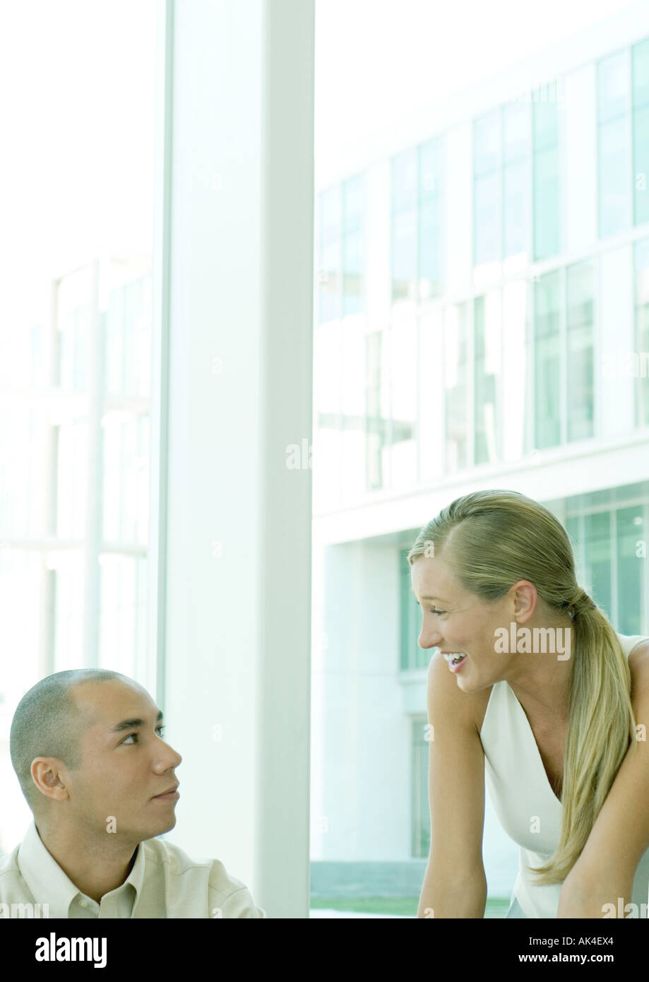 Two office workers chatting Stock Photo - Alamy