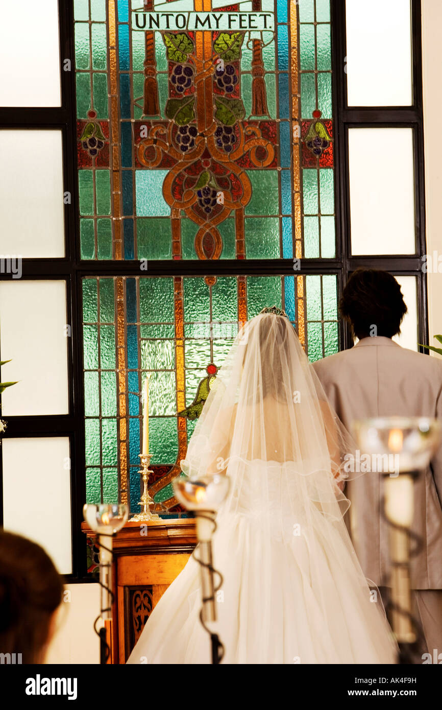 Bride and groom standing in church, rear view Stock Photo - Alamy