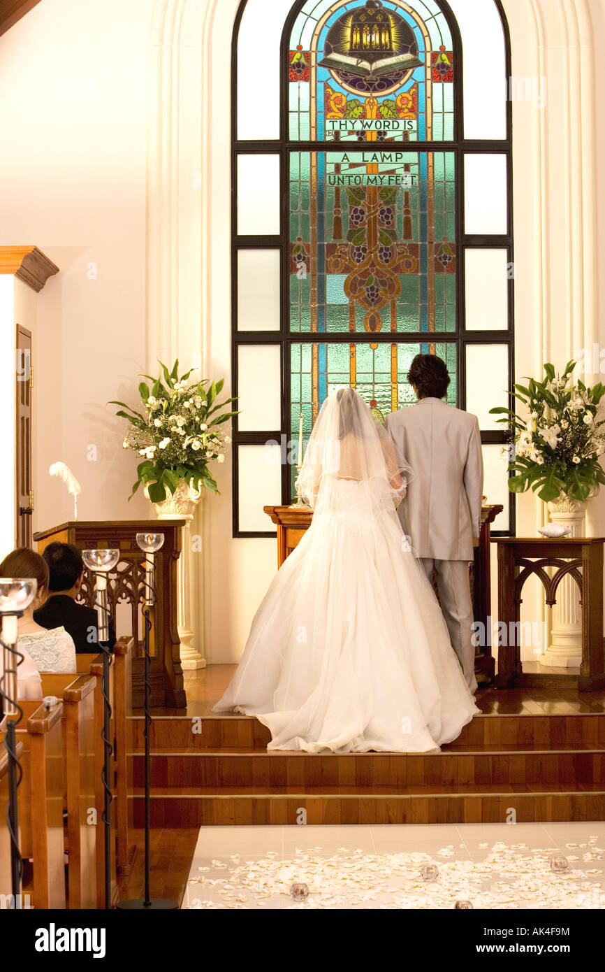 Bride and groom standing in church, rear view Stock Photo - Alamy