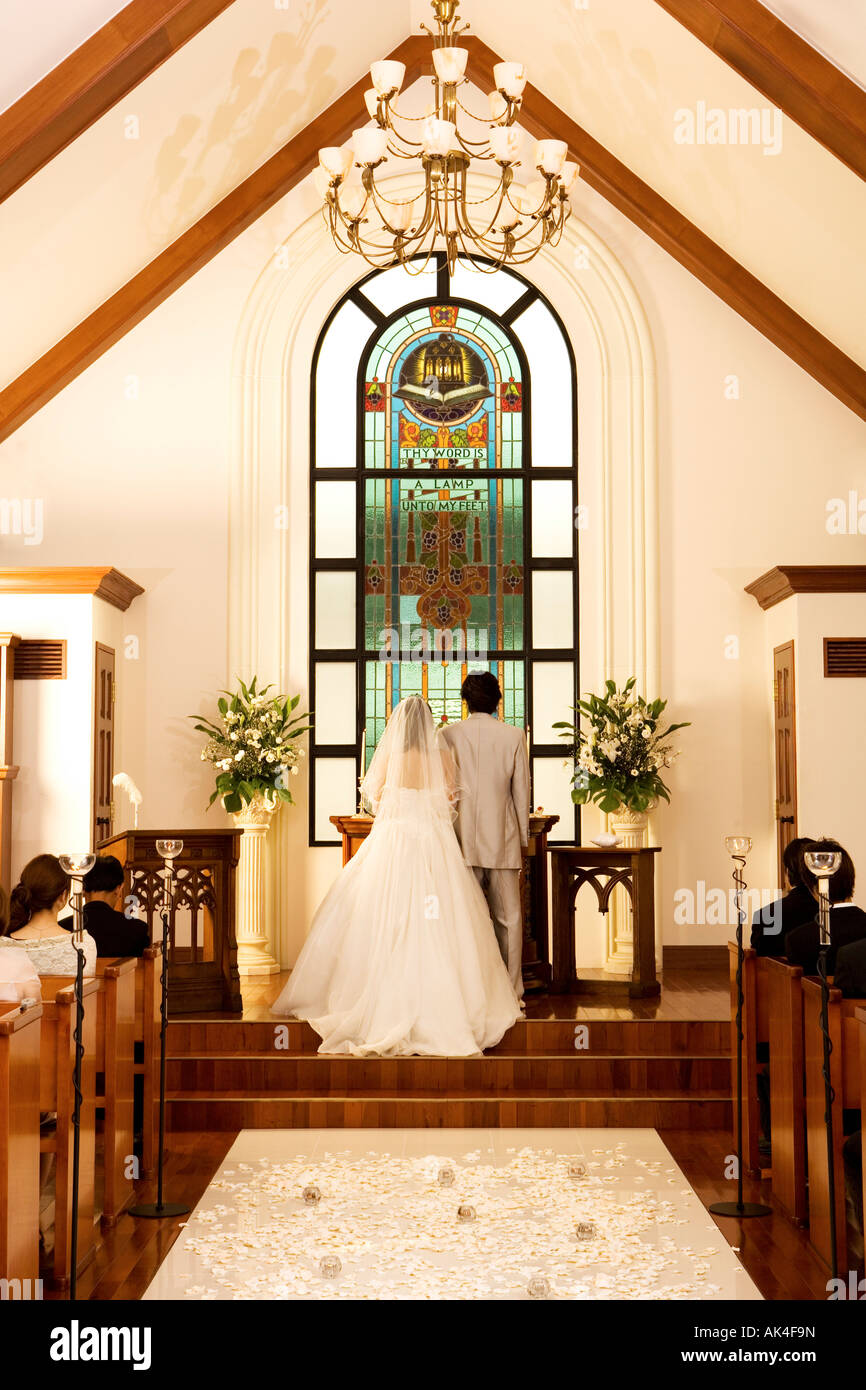 Bride and groom standing in church, rear view Stock Photo - Alamy