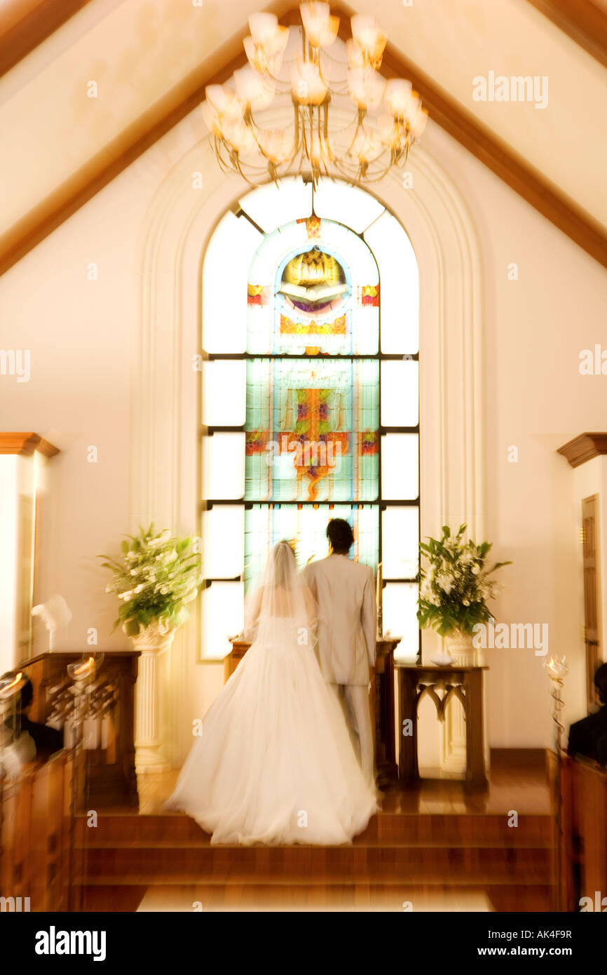 Bride and groom standing in church, rear view Stock Photo - Alamy