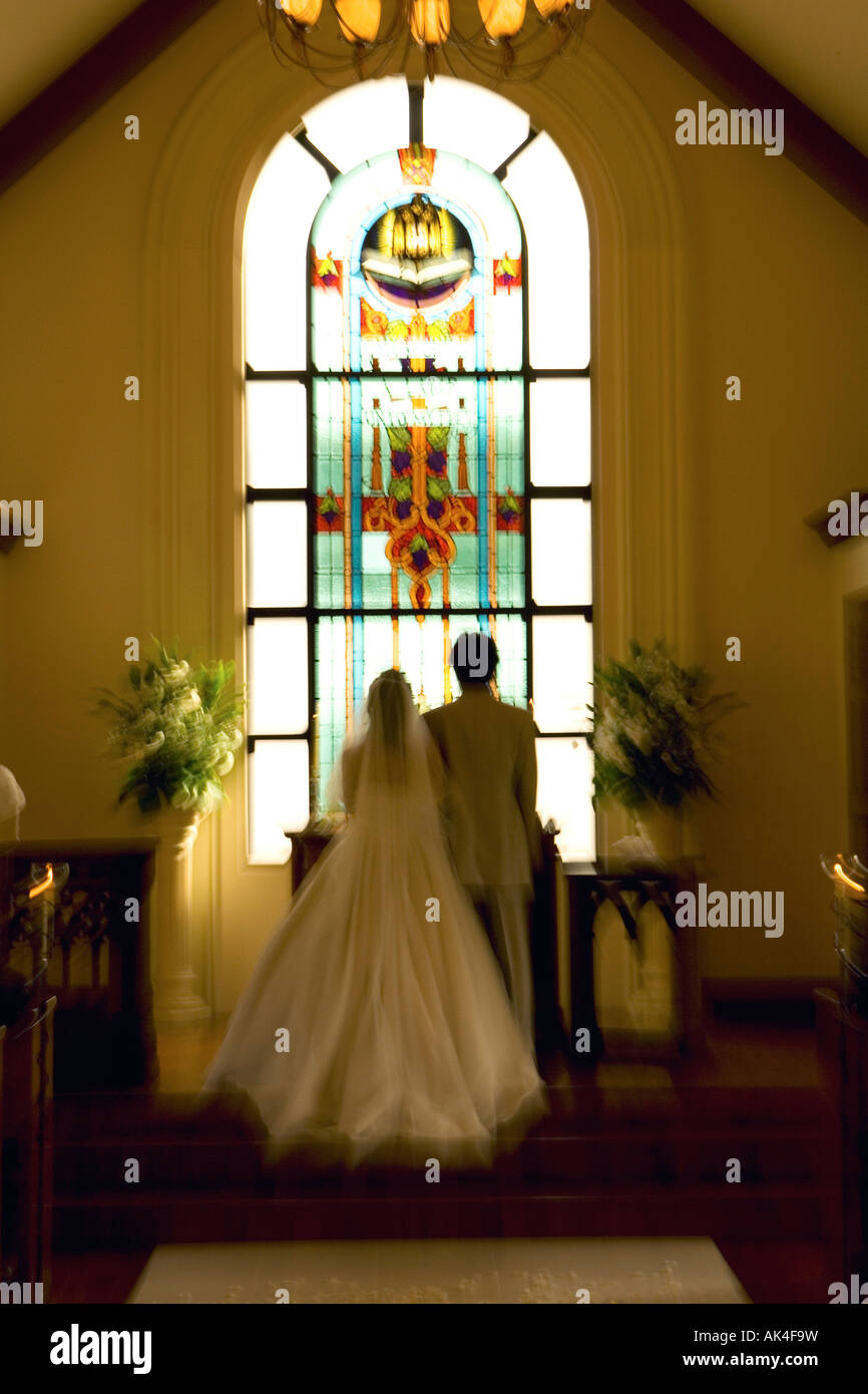 Bride and groom standing in church, rear view Stock Photo - Alamy