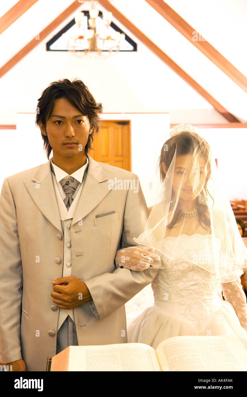 Bride and groom getting married in church Stock Photo - Alamy