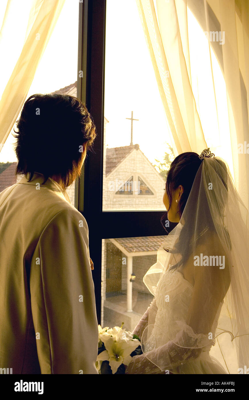 Newlywed couple looking out of window, rear view Stock Photo - Alamy