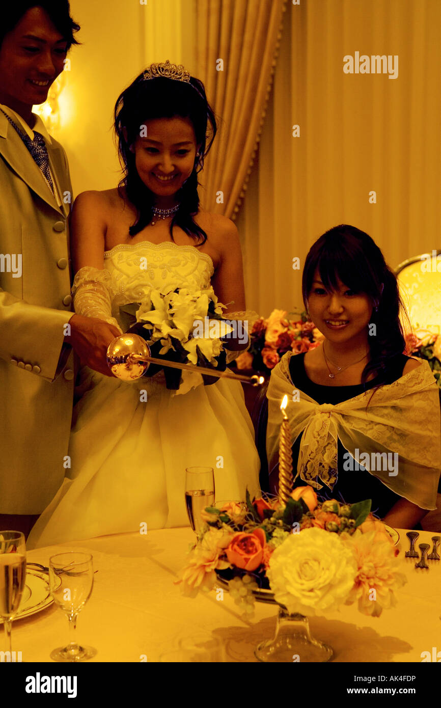 Bride and groom lighting a candle Stock Photo - Alamy