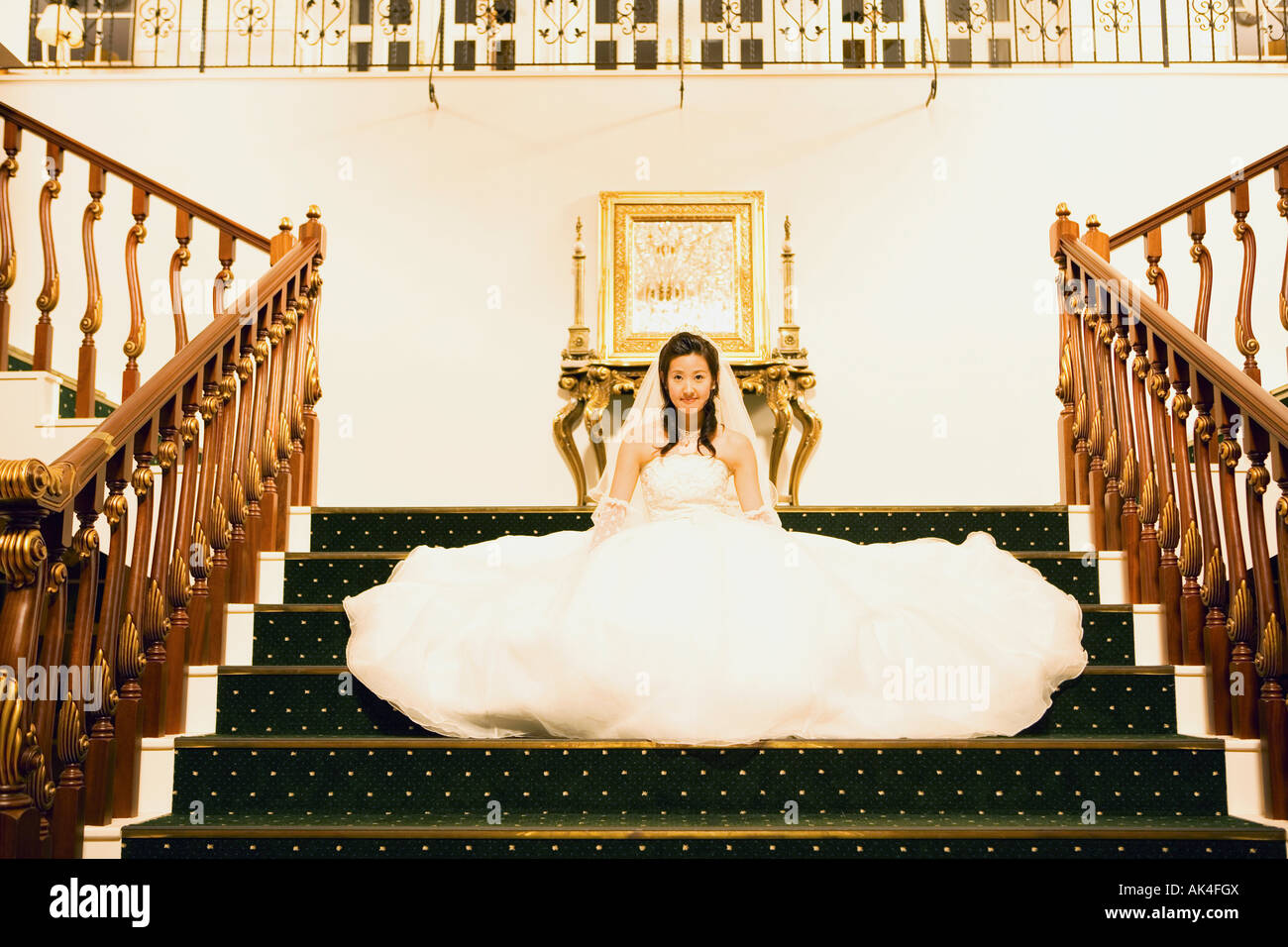 Portrait of bride sitting on steps Stock Photo - Alamy