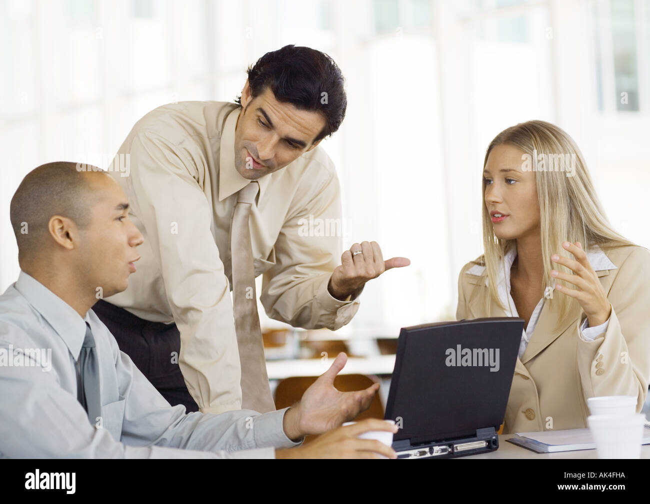 Three young exectives having discussion Stock Photo - Alamy