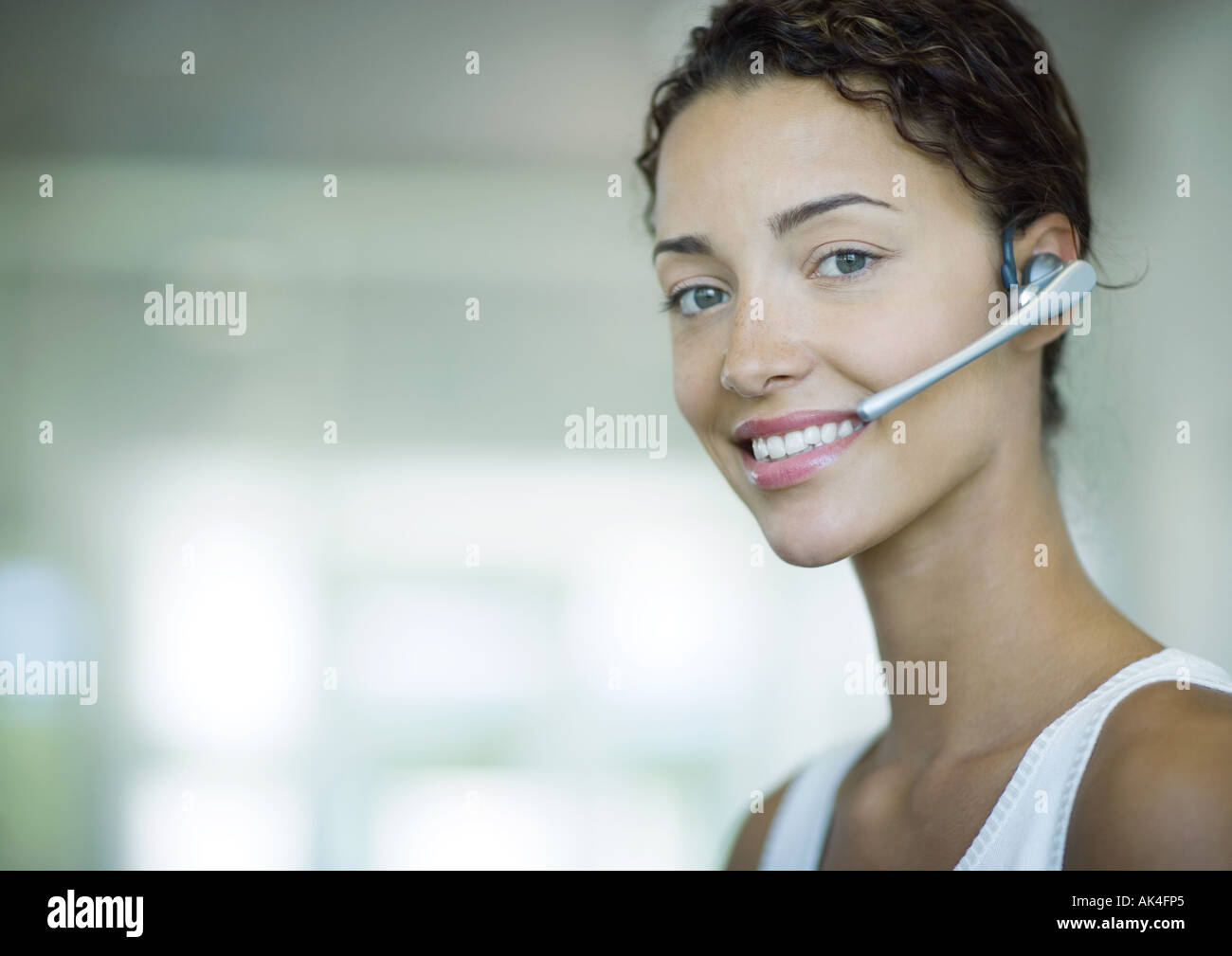 Woman wearing headset and smiling Stock Photo - Alamy