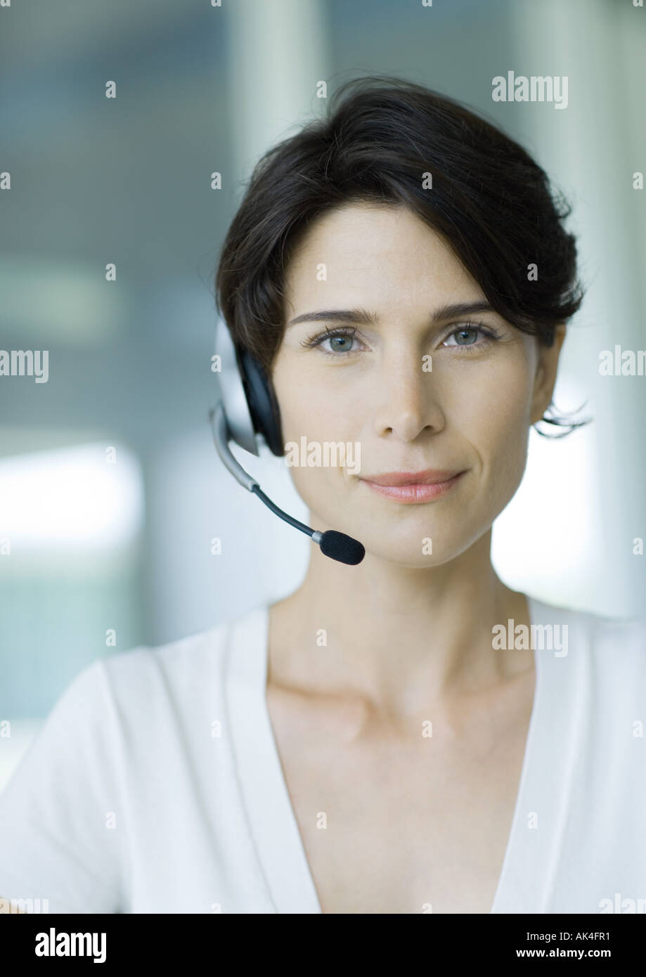 Woman wearing headset and smiling Stock Photo - Alamy